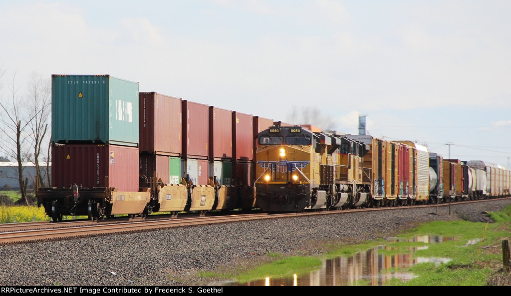 UP 8050 leads a manifest past z train